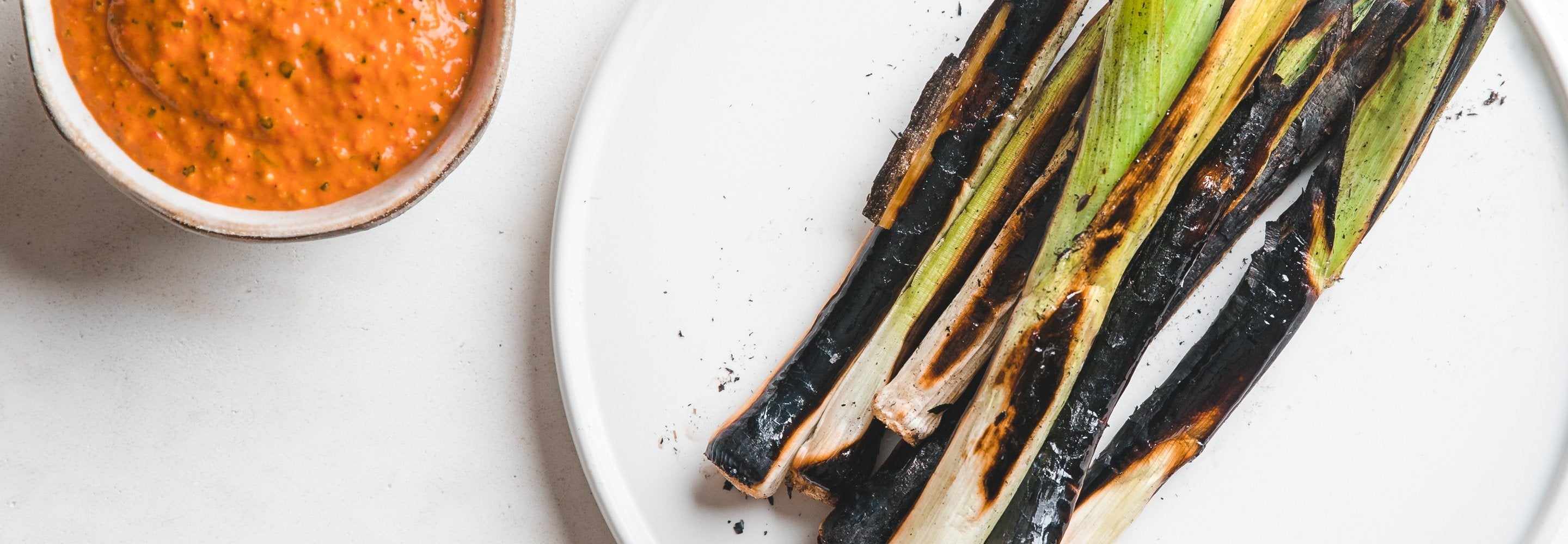 Charred Baby Leeks with Romesco Sauce Recipe | Gozney US